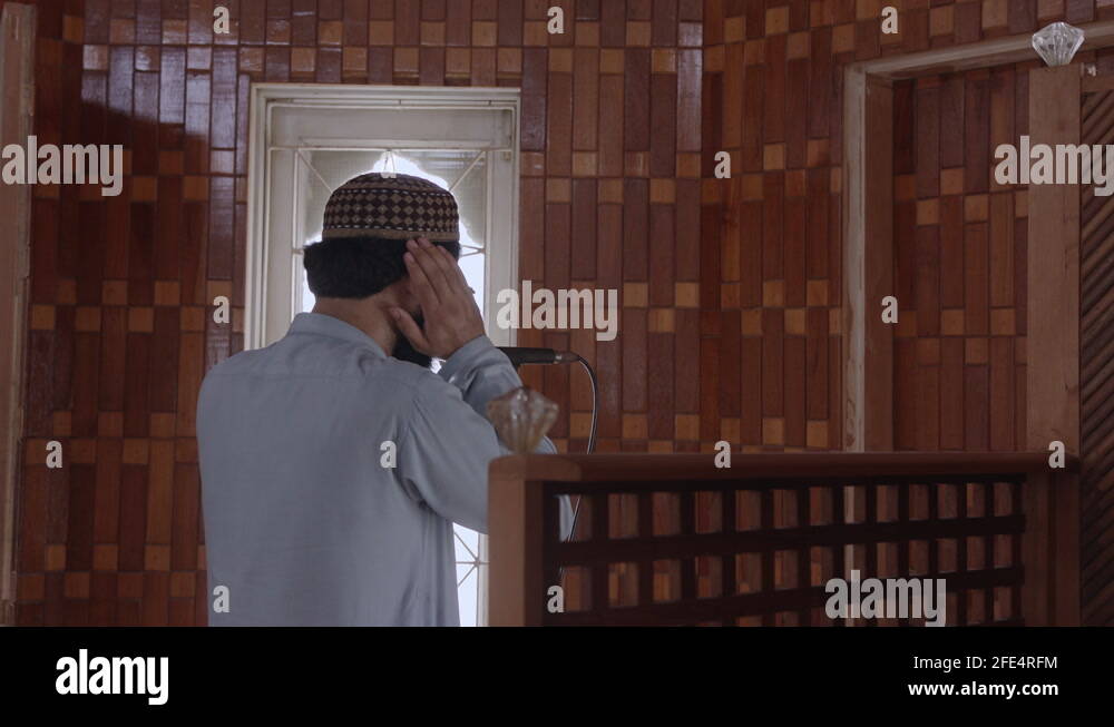 Muslim man calls for prayer (Adhan) also called Azaan at a mosque Stock ...
