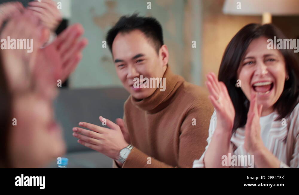 Workplace diversity. Happy multiethnic business people stand up, clap ...