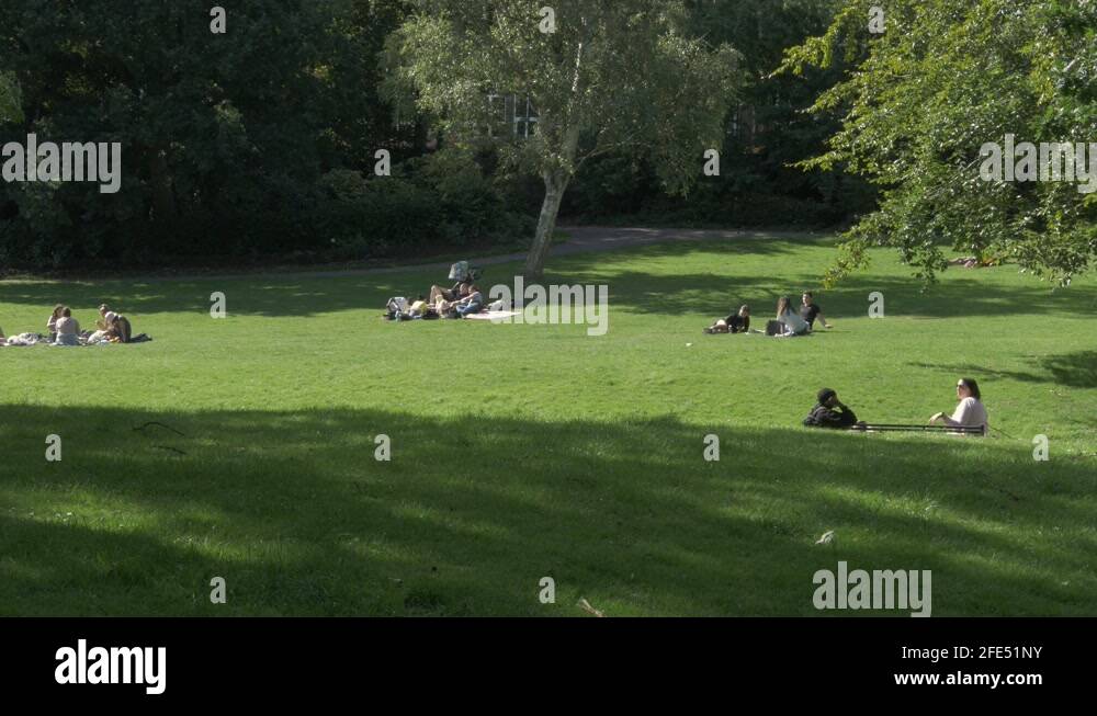 People sunbathing in british summer. Groups of people lying in the ...
