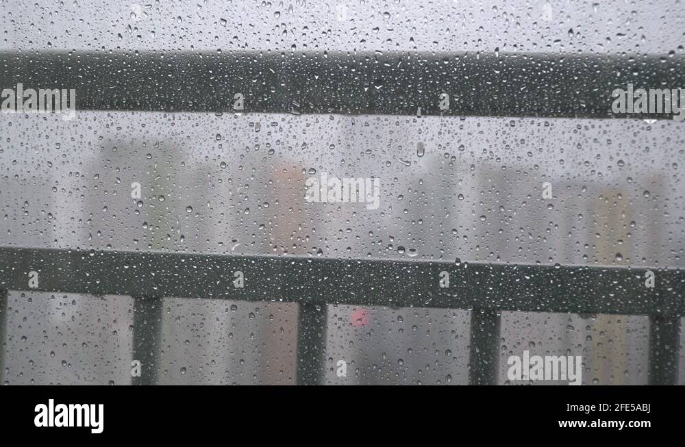 Tall Buildings Seen Through The Blurry Glass Window With Raindrops ...