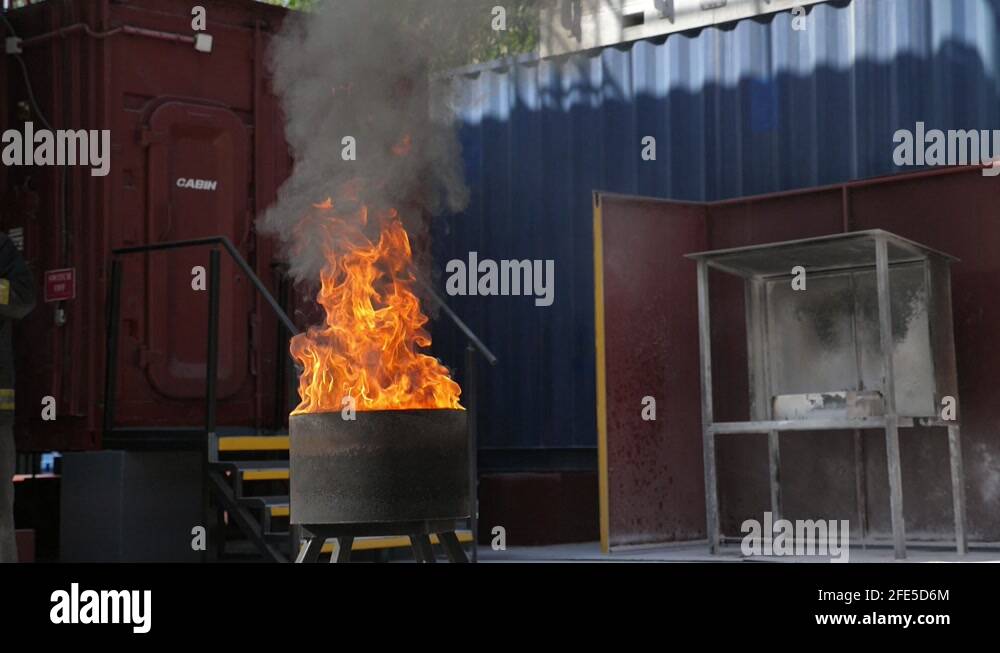 Forks of flire plays in barrel; firefighter adds liquid and getting ...