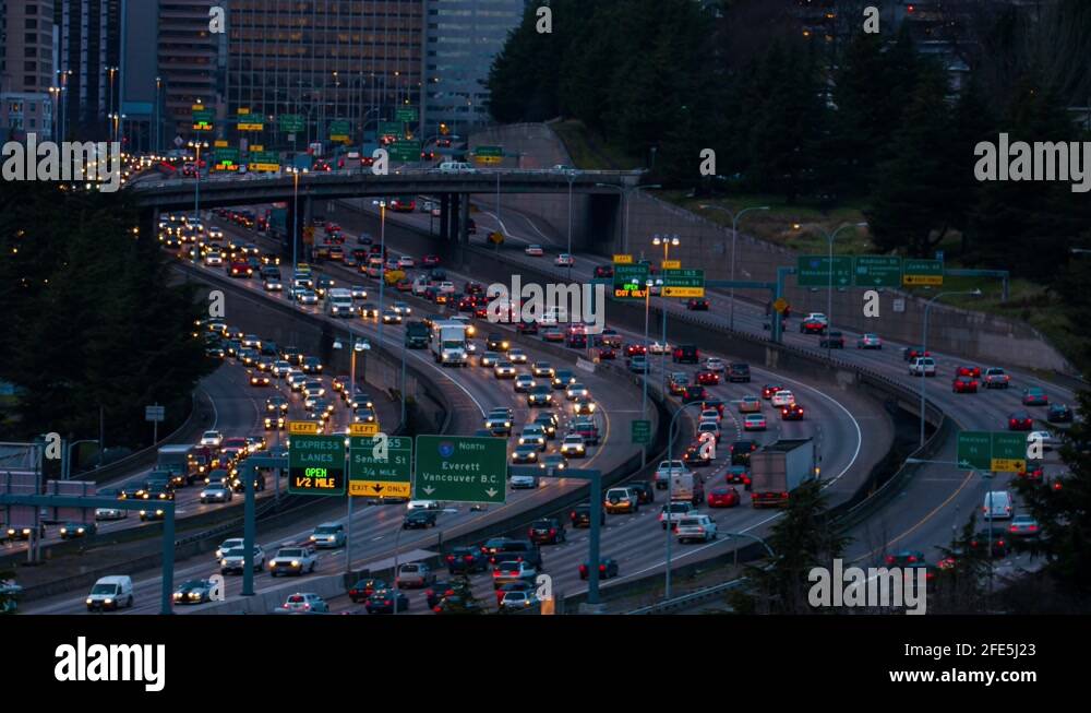 Cars Driving At The I-5 And I-90 Interstate Highway With Headlights On ...