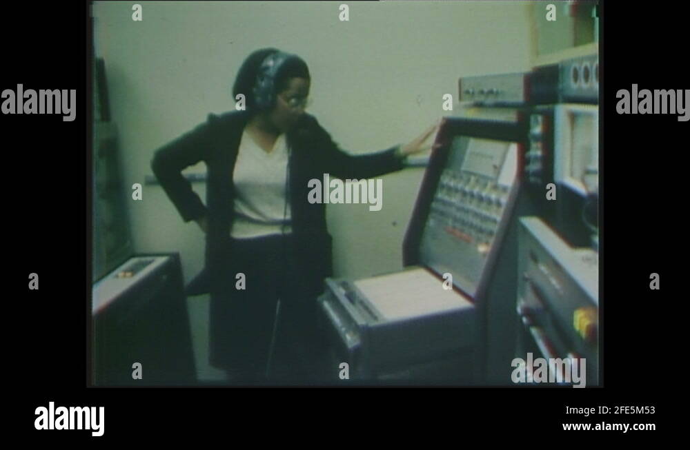 1970s:Young Black woman on headset in NASA Lab next to computer ...