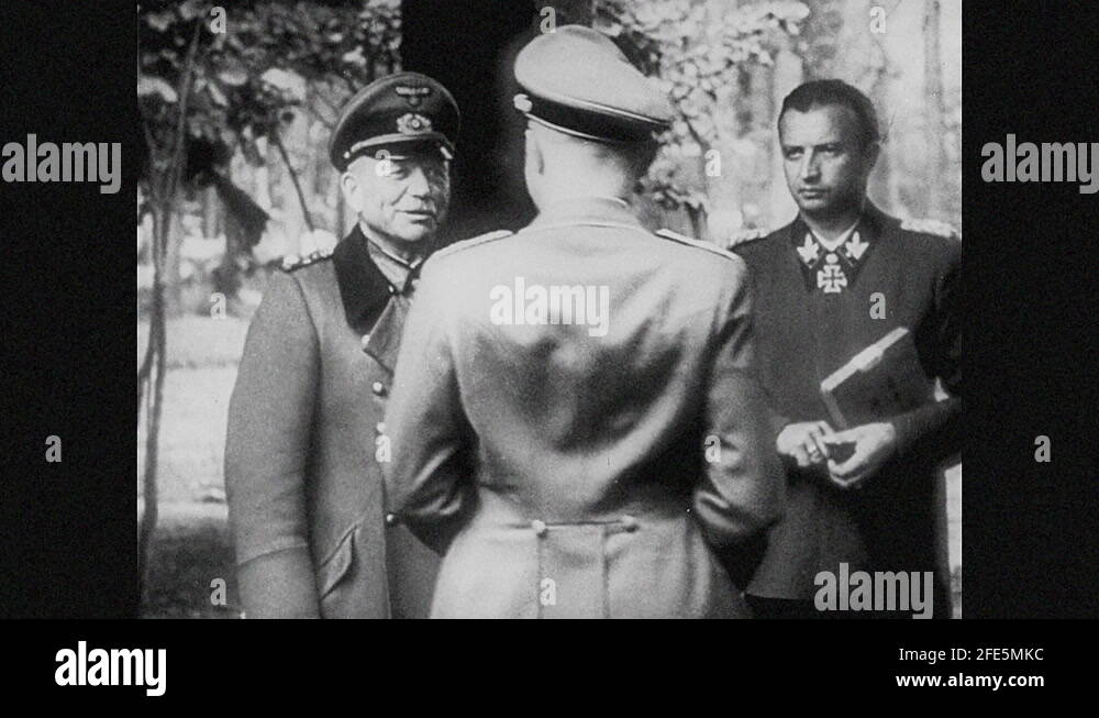 1940s Germany: Nazi officers talking, pan to Adolf Hitler with officers ...