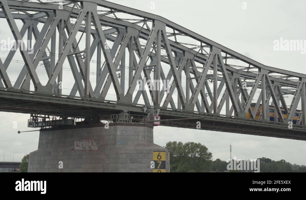 A Dutch intercity train passes over the railway bridge at Hedel in the ...