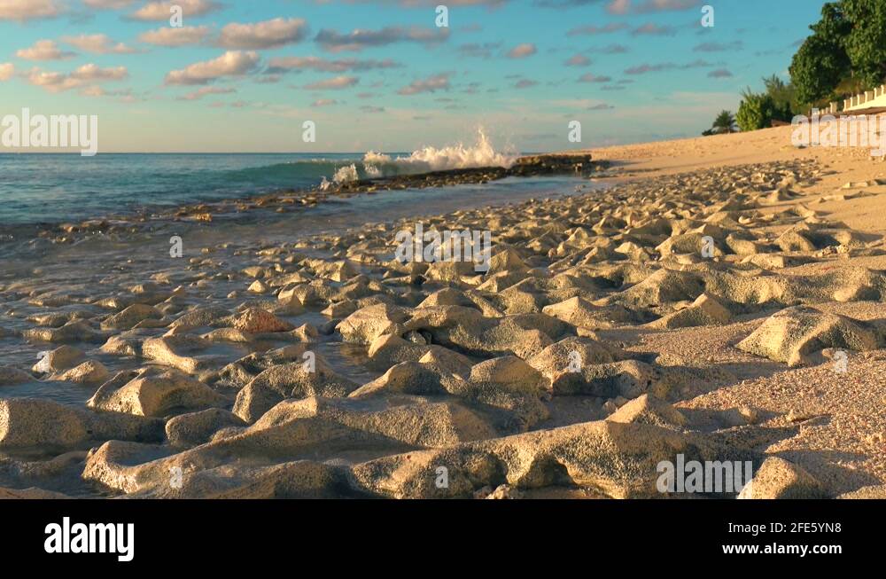 Calm waves rushing over the rocky limestone shorelines of Grand Turk ...