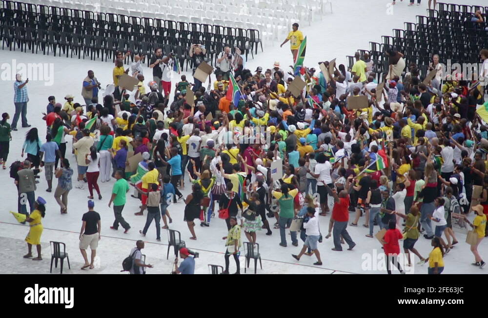 people dancing & flag waving, at Mandela Memorial event Cape Town ...