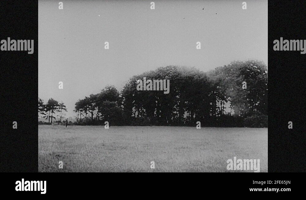 1940s Germany: Tanks fire from tree line. Soldiers load shells into ...