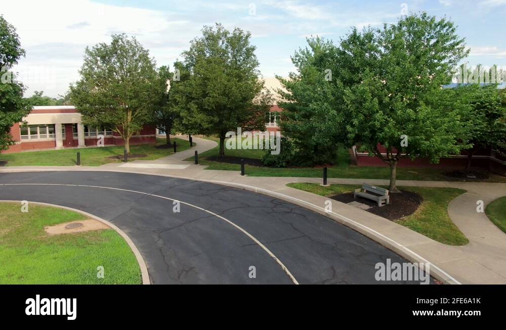 School bus point of view POV entering school building campus, new red ...