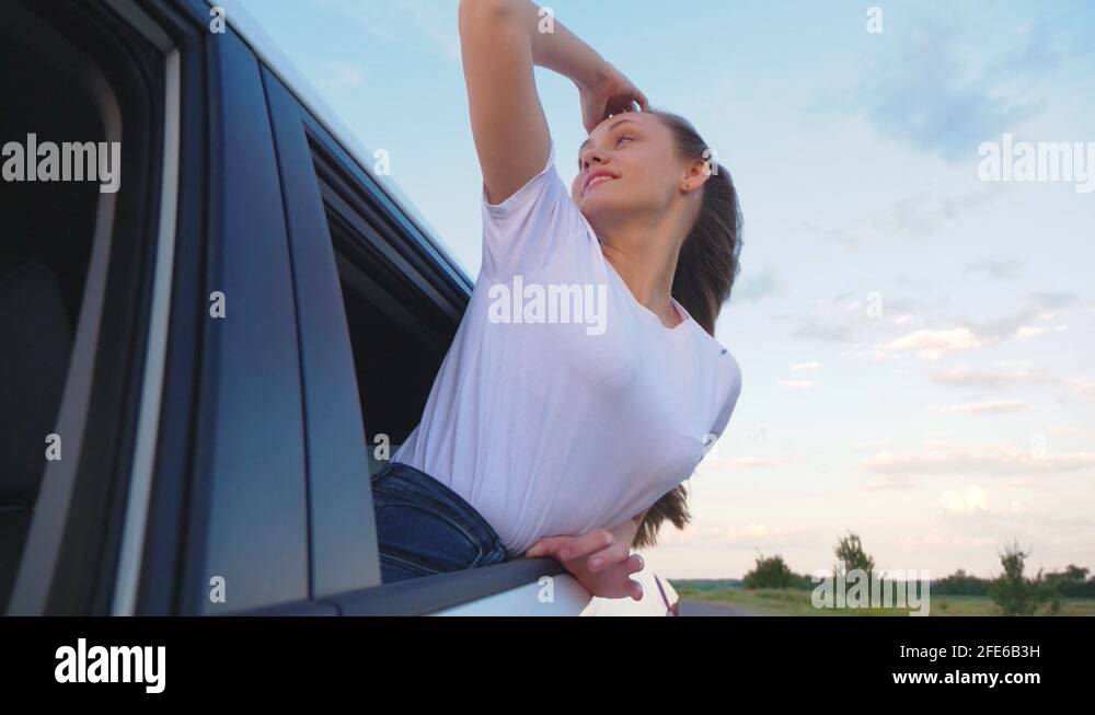 A happy family travels by car. A teenage girl climbed out of a car ...