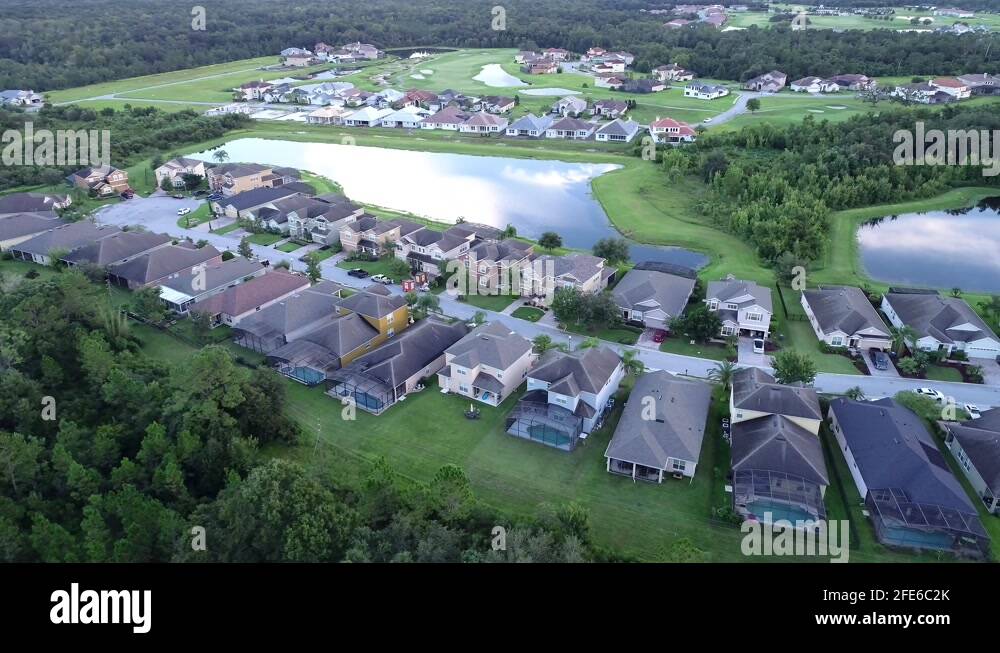 An aerial flyover of a residential subdivision HOA single family homes ...