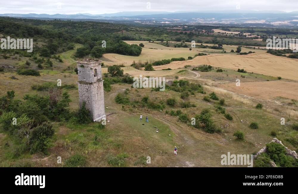 Wide rotating aerial of abandoned church tower ruins in Spanish ghost ...