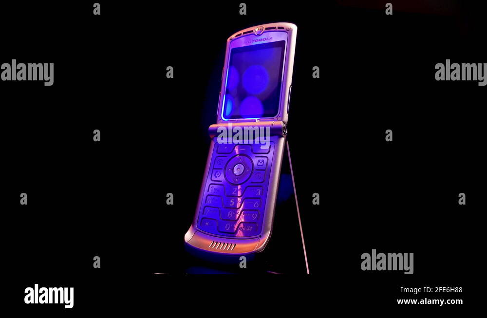 Spinning Motorola Razr V3 Opened Flip Mobile Phone on Black Background ...