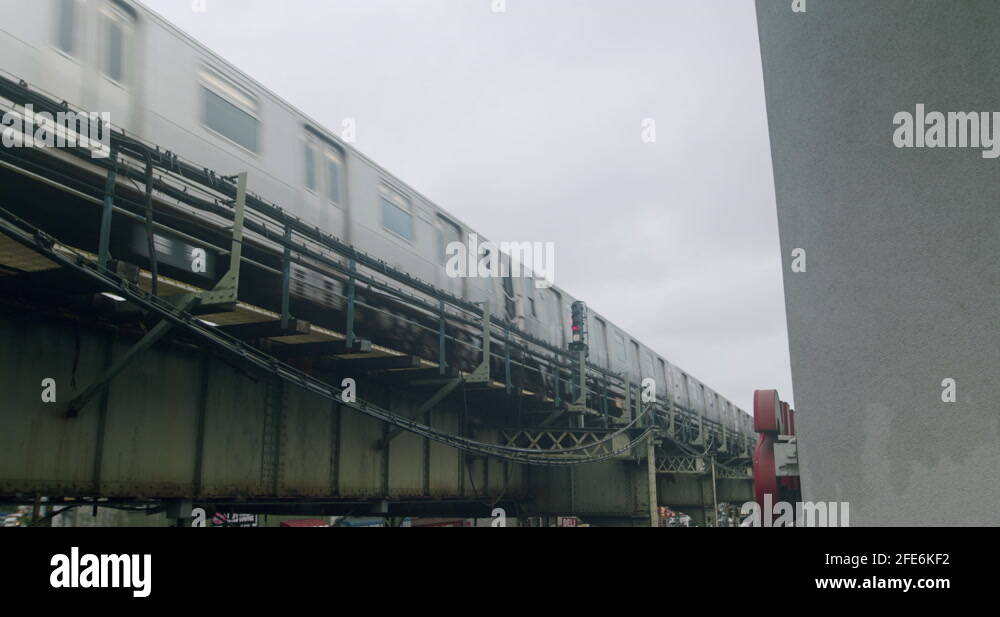 New York City MTA Subway Train Quickly Passes Through Overhead Station ...