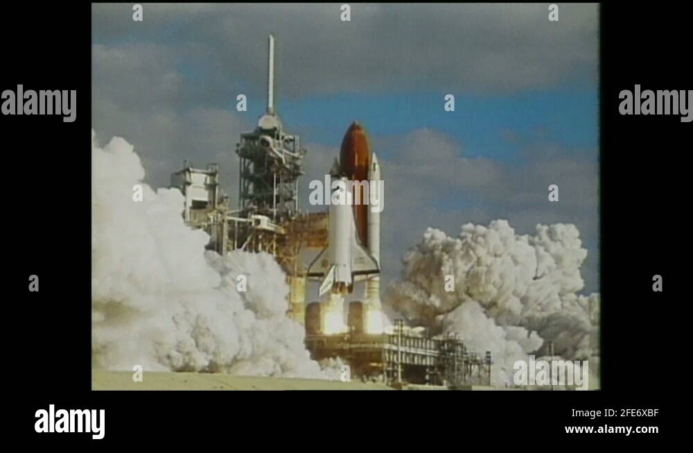 1990s: Space shuttle launching. Long shot of shuttle launching. Zoom in ...