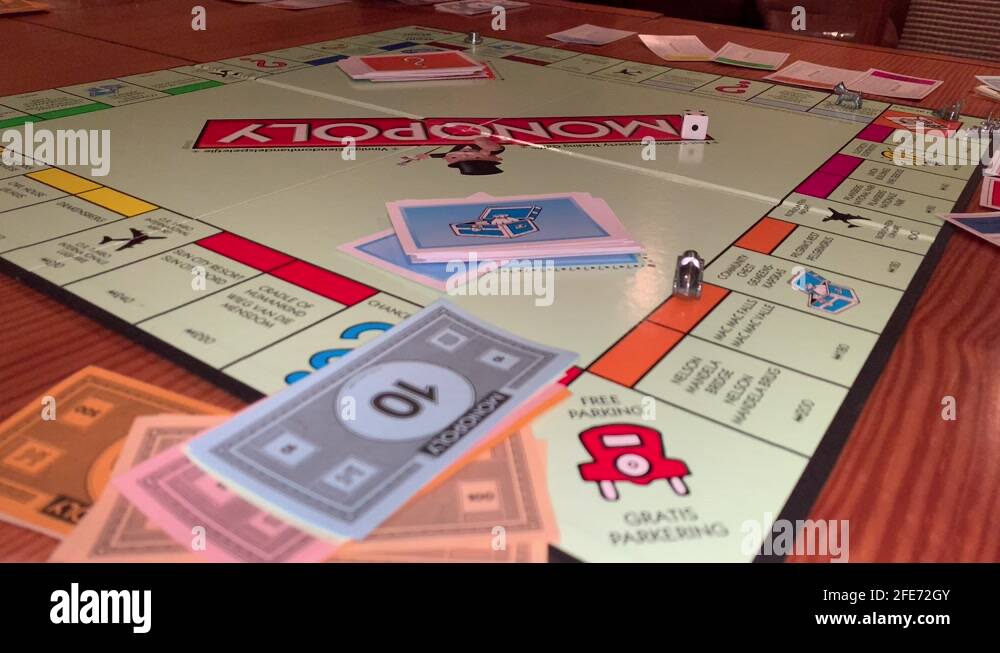 Monopoly game with rolling of dice on the monopoly board with the ...