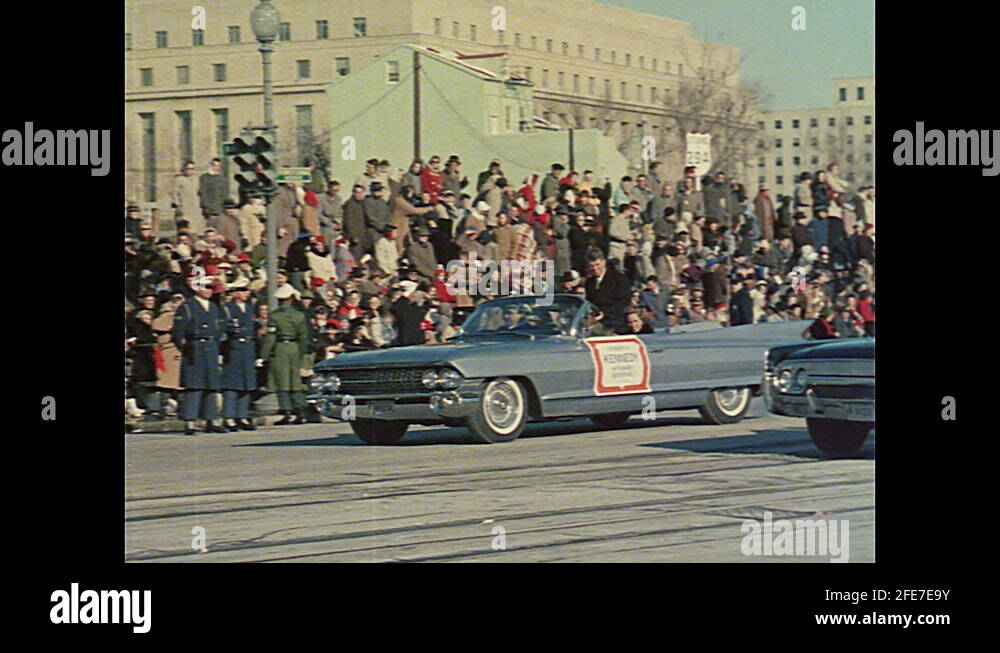 1960s: Cars carrying inauguaration dignitaries drive by, with ...