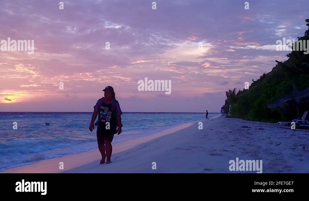 On the beach background texture of playful female gets a tan by blue ...