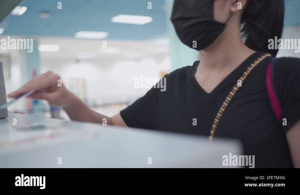 Young Asian woman hand in travel documents, ID card to check-in counter ...