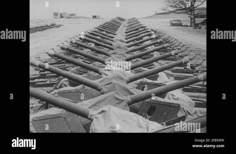 1940s: Rows of tanks, trucks, and planes line fields. Convoy of trucks ...