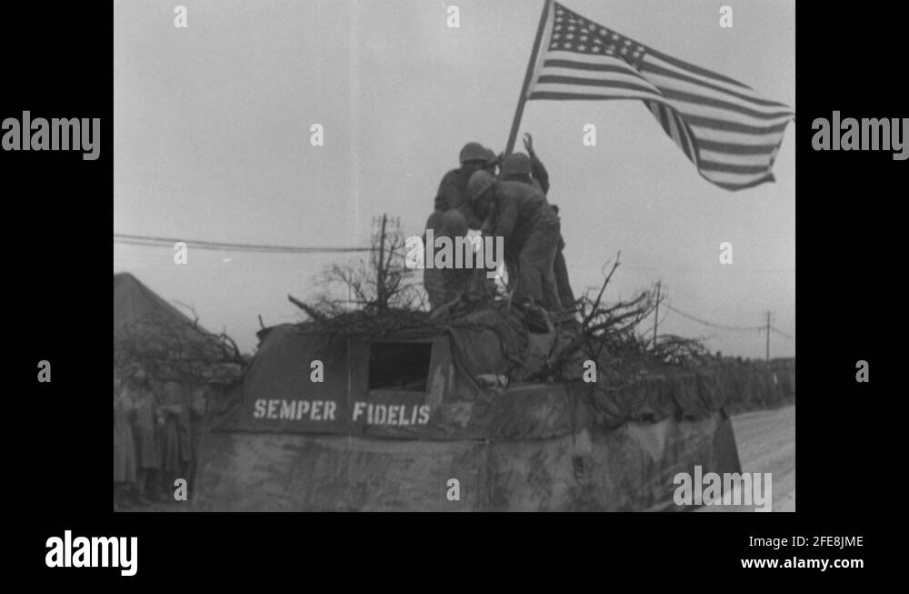 1940s: Soldiers on float in parade recreate Iwo Jima. Soldiers on side ...