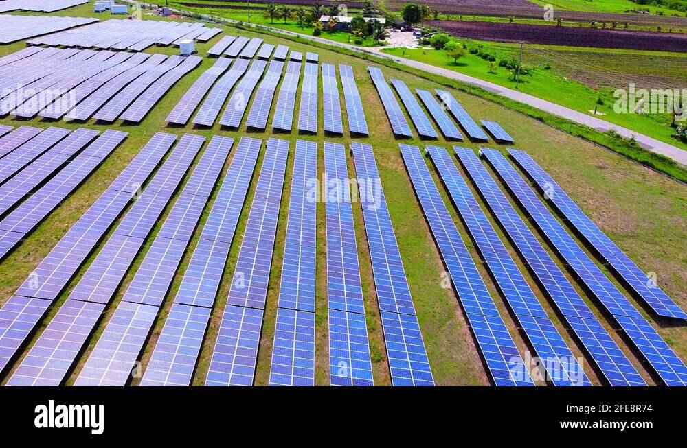 Ariel of a small Solar Panel farm with sunlight hitting the panels ...