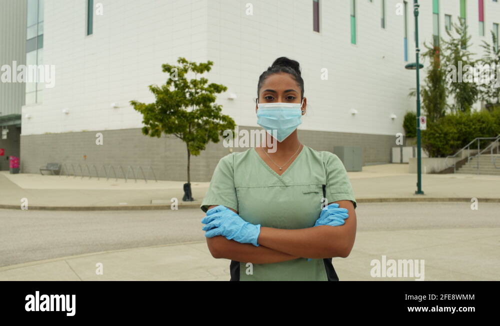 Indian woman, POC, nurse doctor wearing PPE uniform, mask, gloves ...