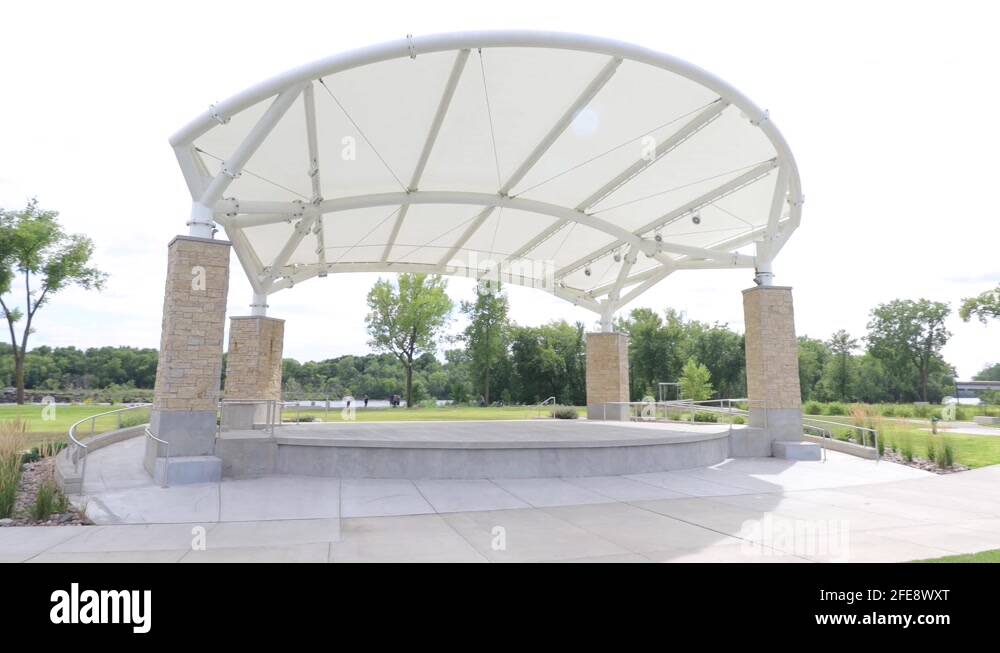Large roof for sun and rain cover structure in riverfront park. Camera ...