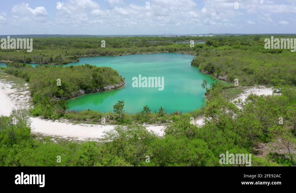 Low altitude flight overlooking blue lake in cap cana, turquoise blue ...