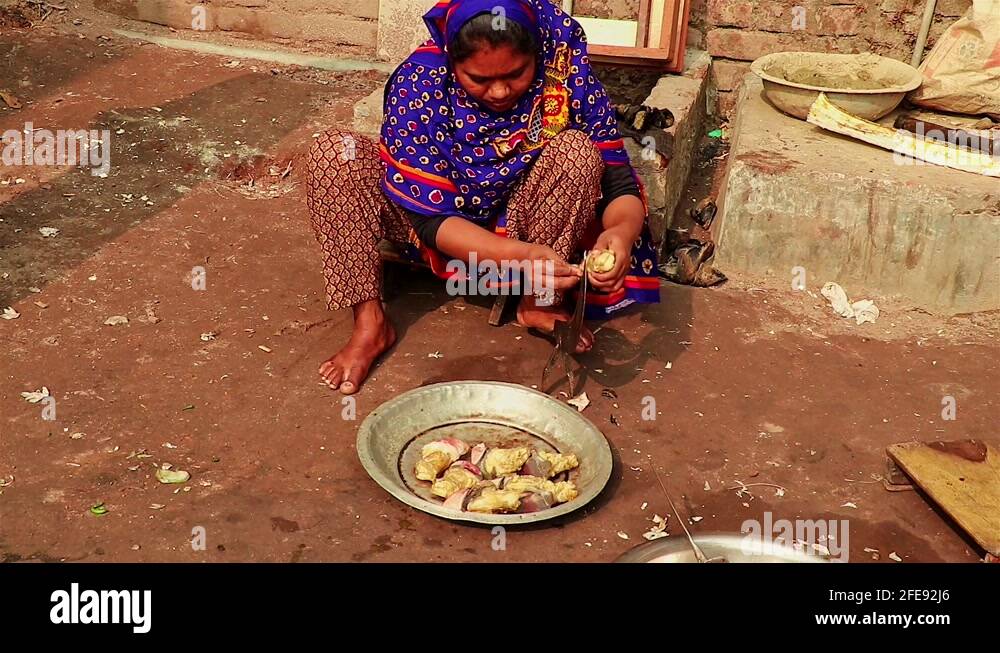 Overhead of Indian woman slicing cow hoof using sharp blade Stock Video ...