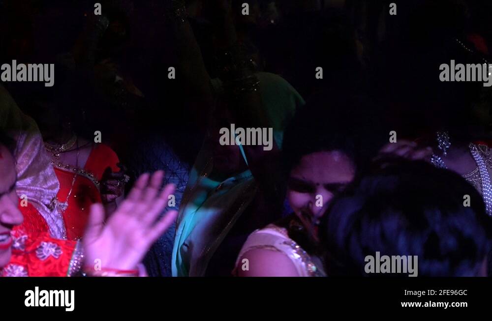 People dancing wildly on the street in the Indian wedding Baraat. It is ...