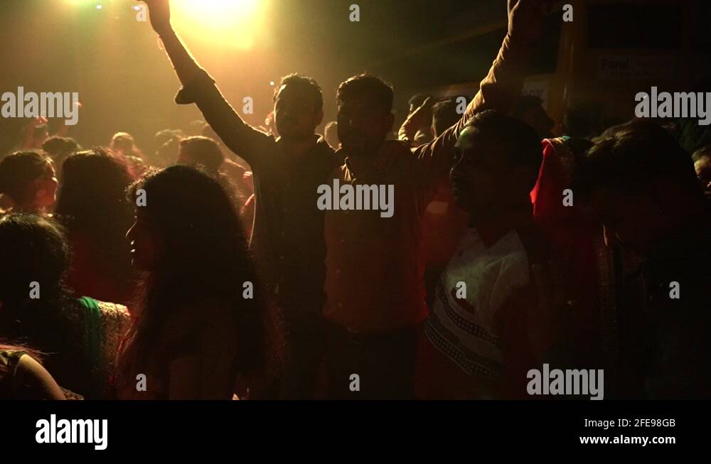 People dancing wildly on the street in the Indian wedding Baraat. It is ...