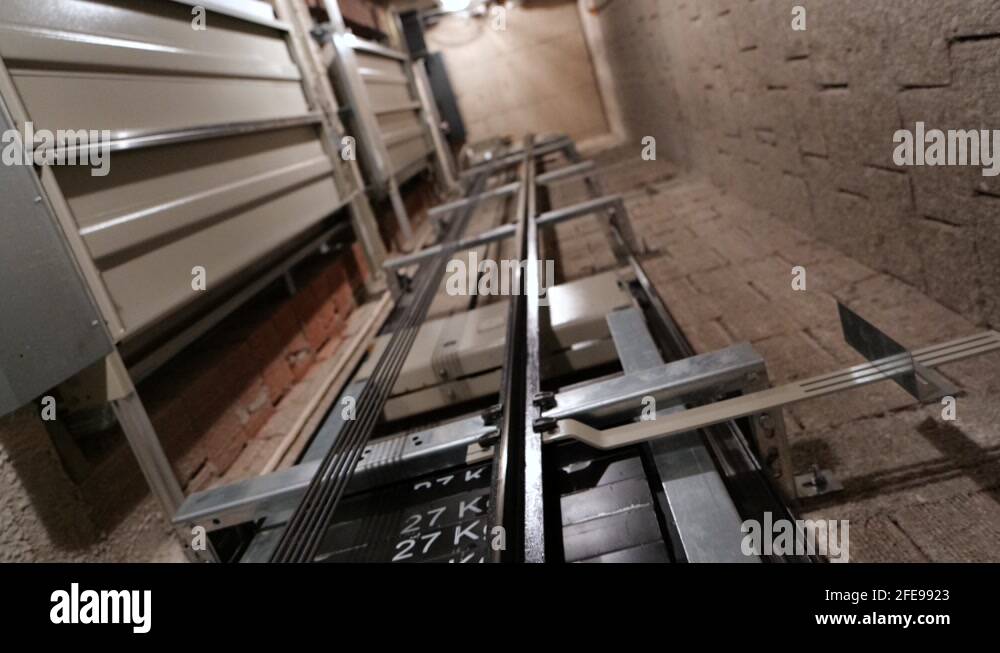 Elevator lift cabines up inside illuminated elevator shaft with ...
