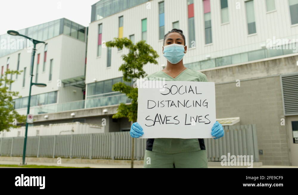 Indian woman, POC, nurse doctor stands in front of hospital wearing PPE ...