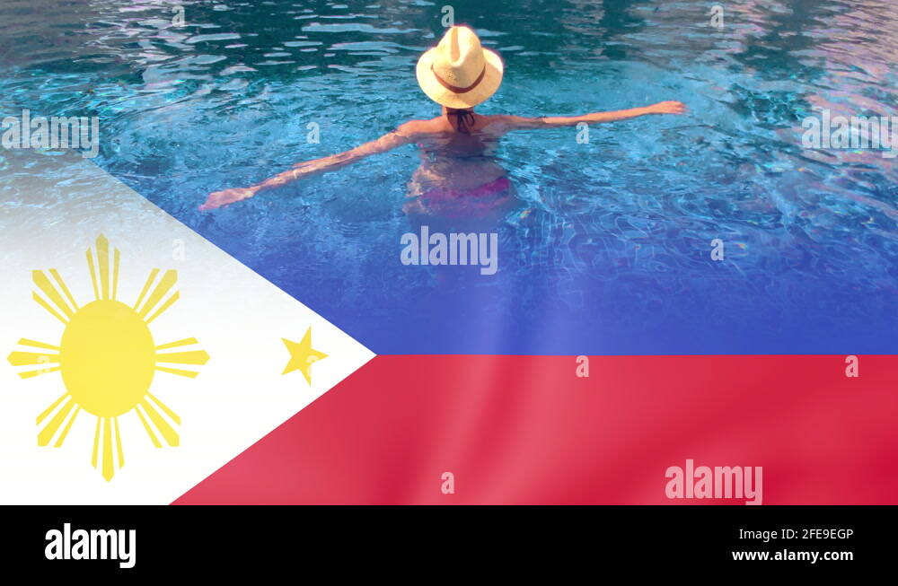 Philipines waving flag and woman with sunhat relaxing in swimming pool ...