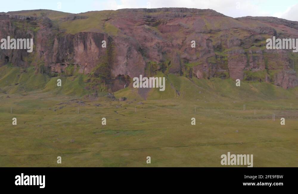 Smooth flight showing a spectacular cliff with waterfalls surrounded by ...