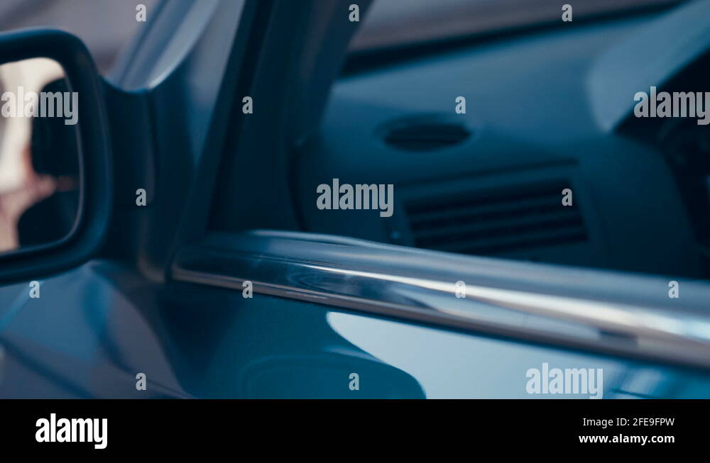 In the open window a man puts his hand in which a cigarette is smoke ...