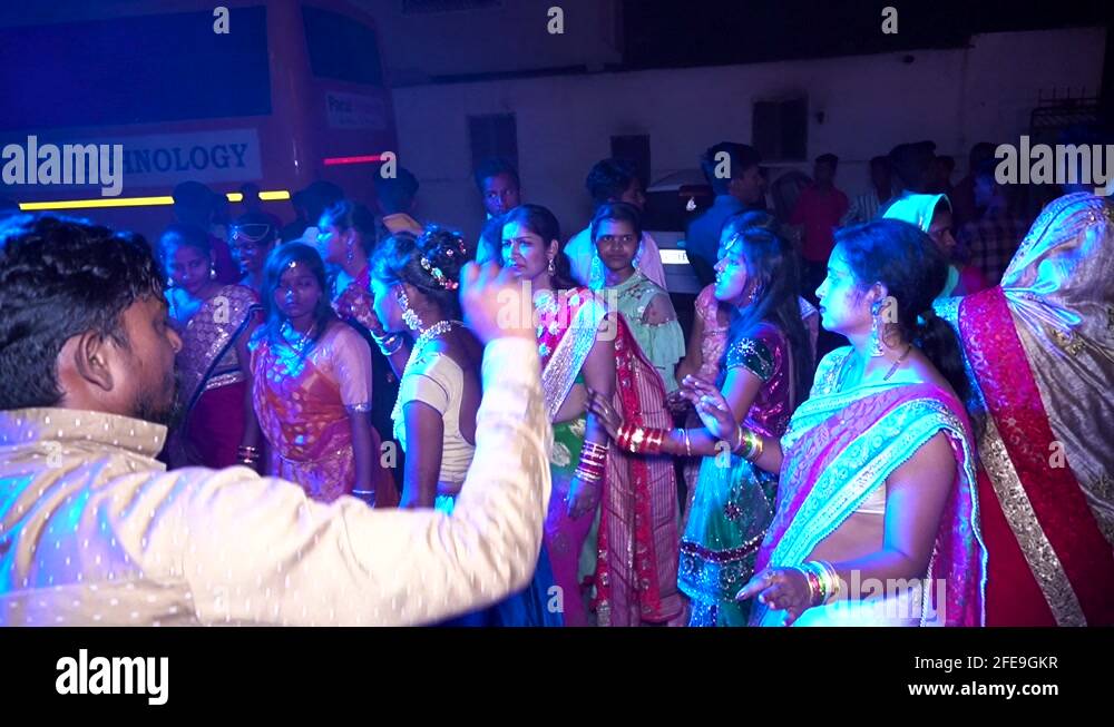 People dancing wildly on the street in the Indian wedding Baraat. It is ...