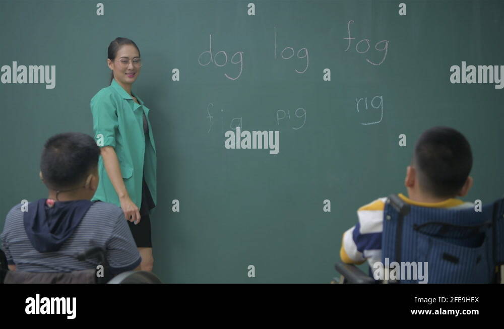 Education concept. The teacher is teaching spelling words to children ...