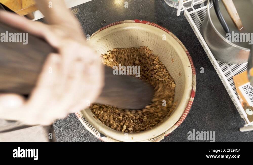 Grinding Peanuts Manually In Circular Motion With A Cylindrical Wood ...