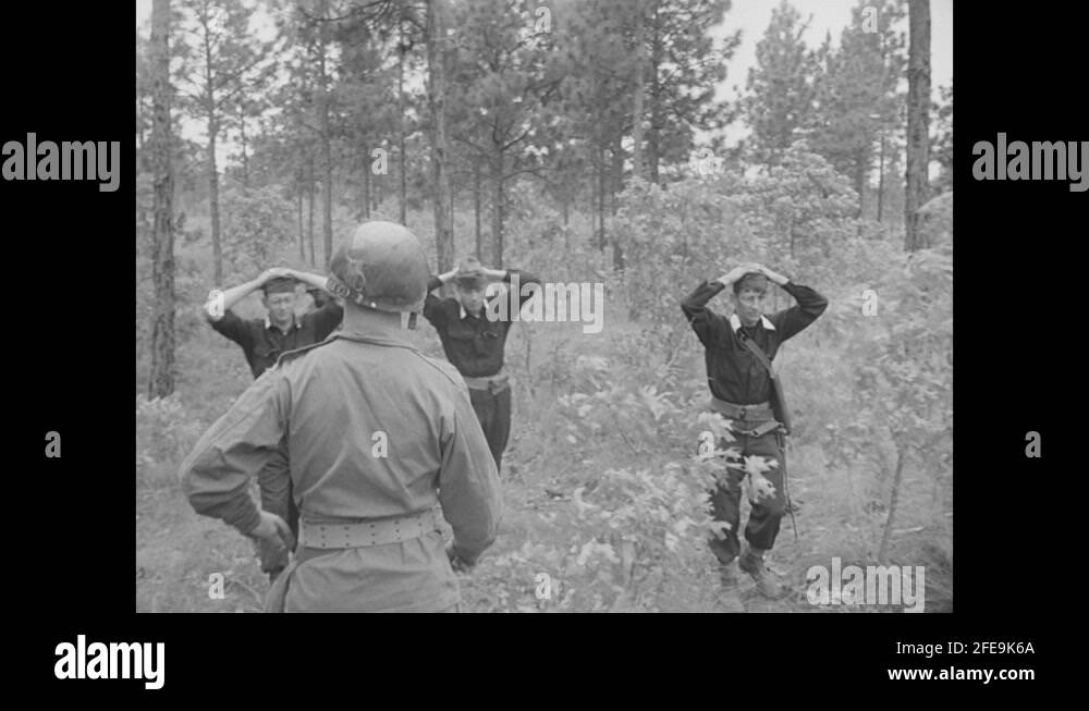 1950s: Soldier captured with hands on head. Man operates camera. Men ...