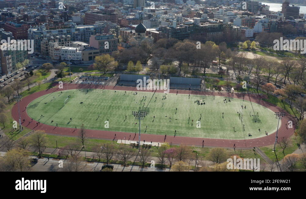 Slow pull out from track field revealing New York skyline Stock Video ...