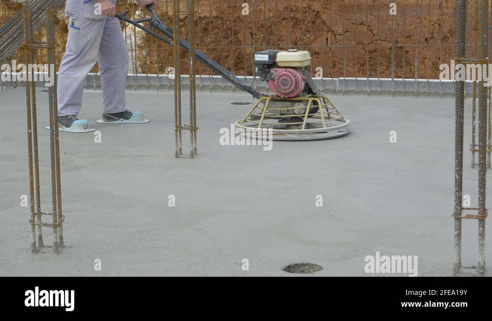 CLOSE UP: Unrecognizable contractor polishes drying concrete slab with ...