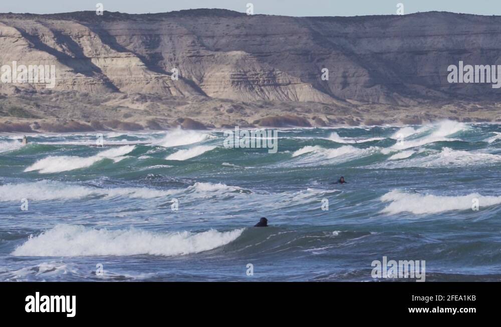 Two Men Swimming Opposite The Extreme Waves On The Rough Sea In ...