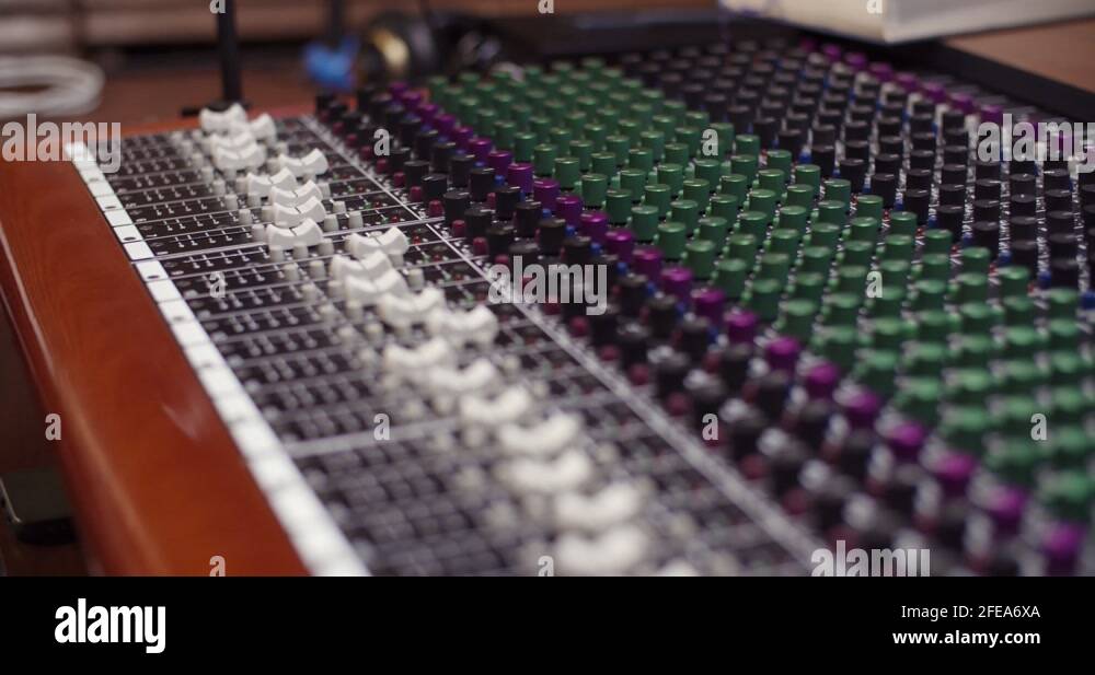 Man in a control room of a recording studioing a fader with a Toft ...