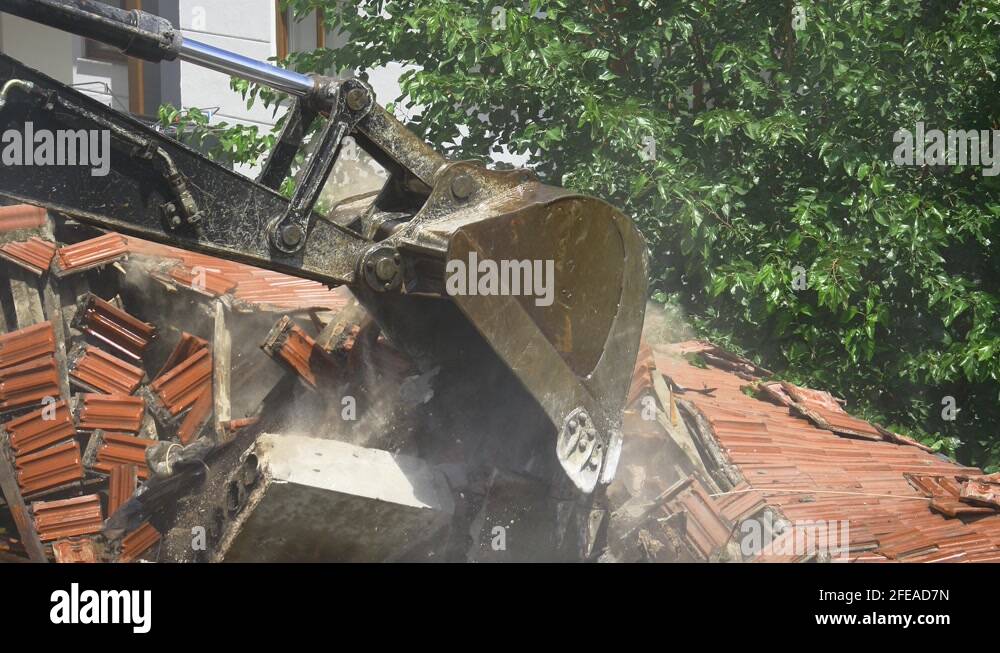 Demolition. Close up of chimney falling down. Broken roof tiles, planks ...