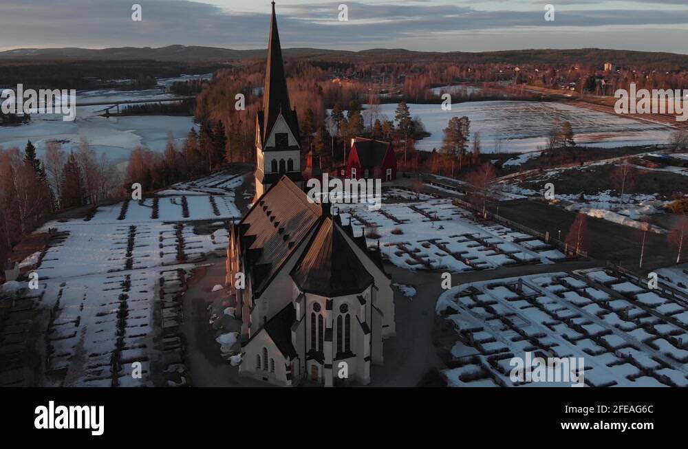 Areal back view of majestic Scandinavian church/cemetery in Vindeln ...