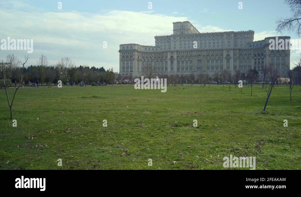 Extreme wide shot of people gathering for a protest in a park in front ...