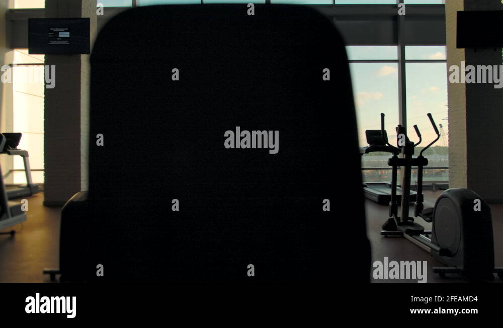 Three unrecognizable people running on treadmills in an empty gym Stock ...