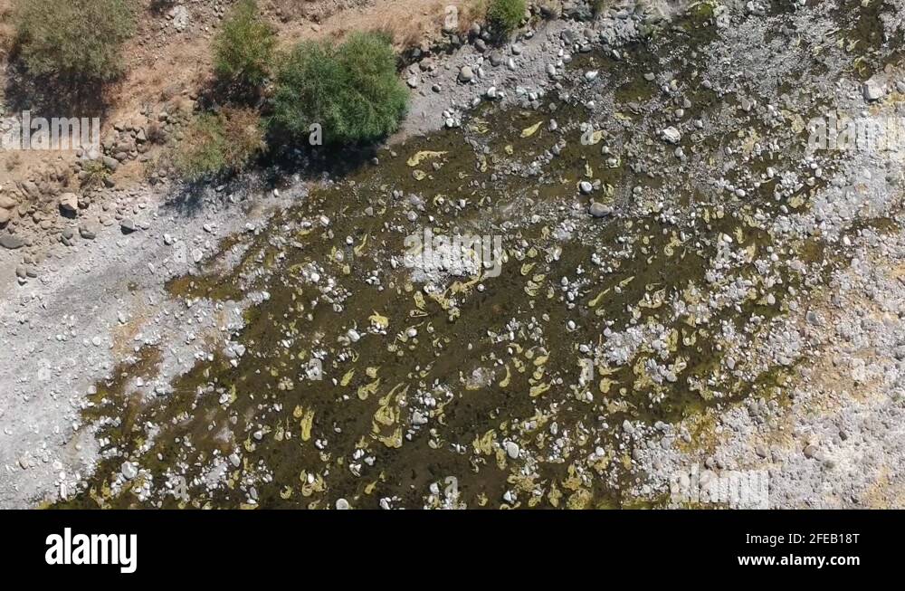 A descending overhead spiral into a drying up river bed in Southern ...